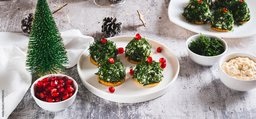 Tuna, egg and dill salad shaped like Christmas trees on crackers on a ...