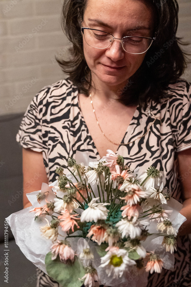 Woman holding wilting bouquet of flowers expressing sadness and ...