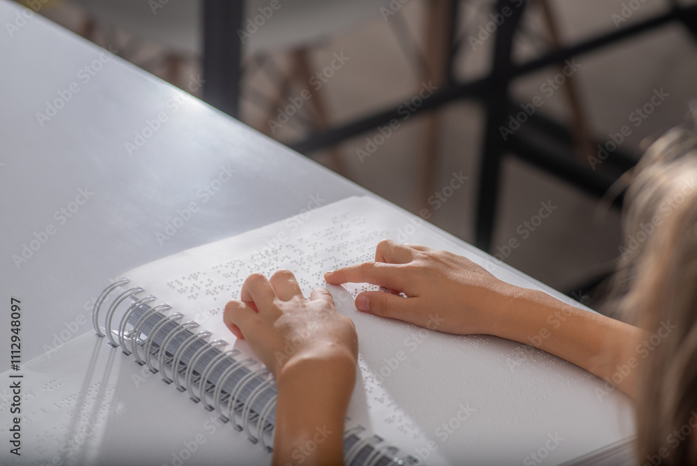 Child's hands touching a book page with Braille Stock Photo | Adobe Stock