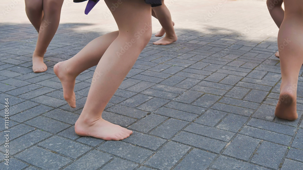 Students celebrating end of school year, walking barefoot on pavement ...