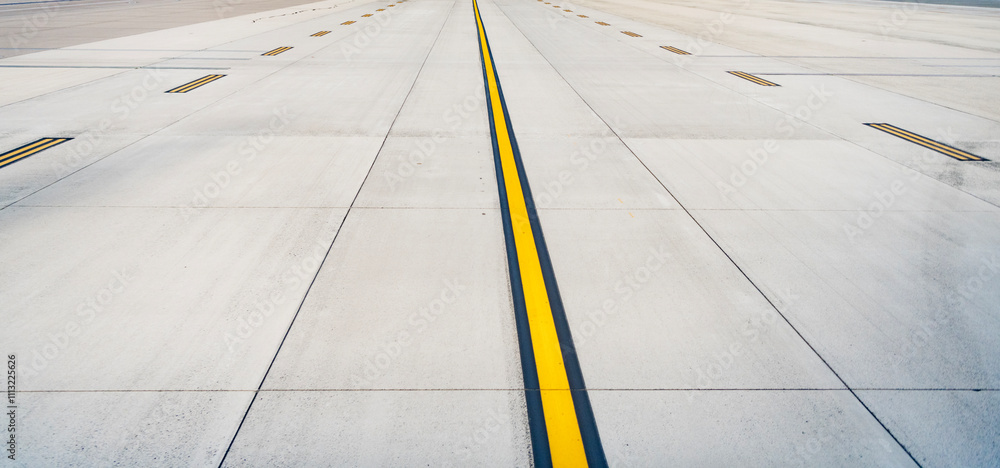 Airport runway. Surface level of long airport runway with yellow ...