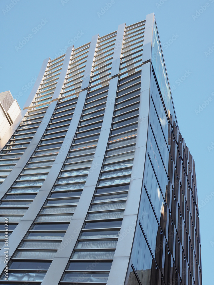 TOKYO, JAPAN -December 3, 2024: View of the top of the curved facade of ...