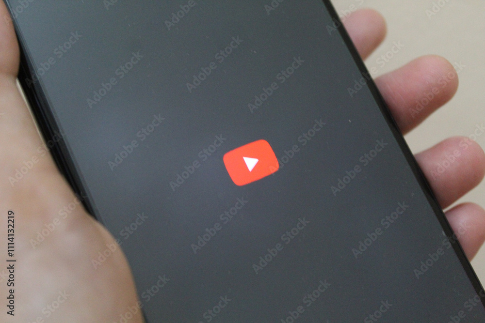 YouTube app logo display on a smartphone, black background, in November ...