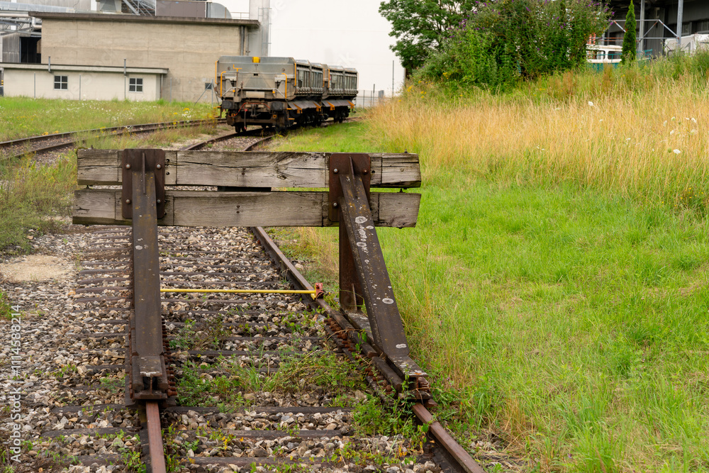 Old weathered wooden and steel buffer stop at the end of a railroad ...