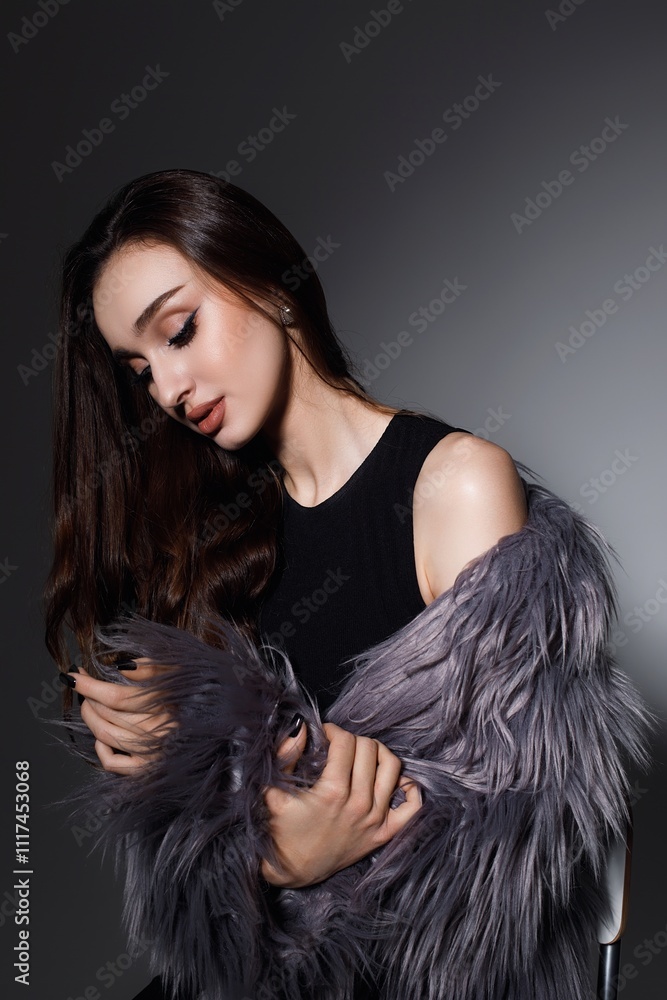 girl in the studio with long brown hair falling freely on her shoulders ...