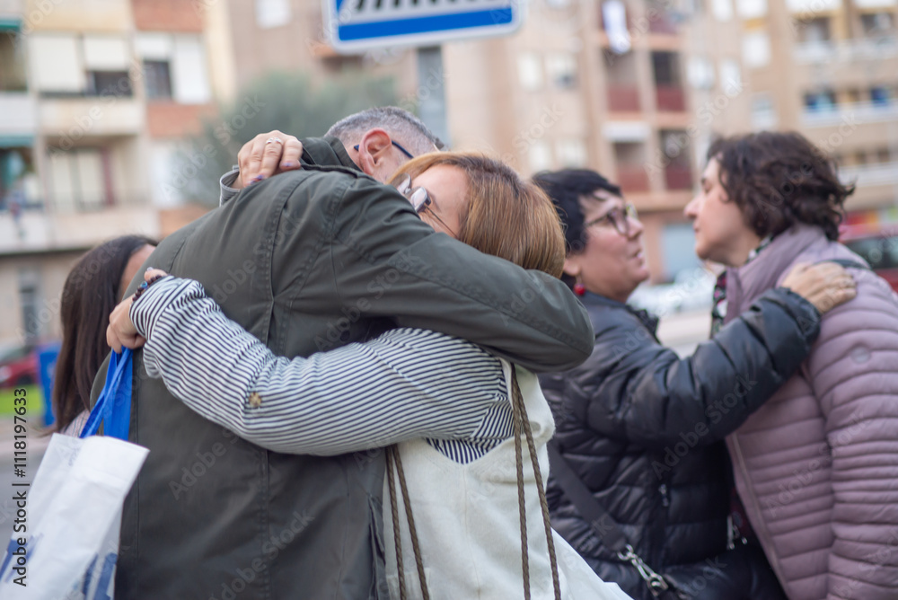 People hugging and greeting each other outdoors. Friends meeting ...