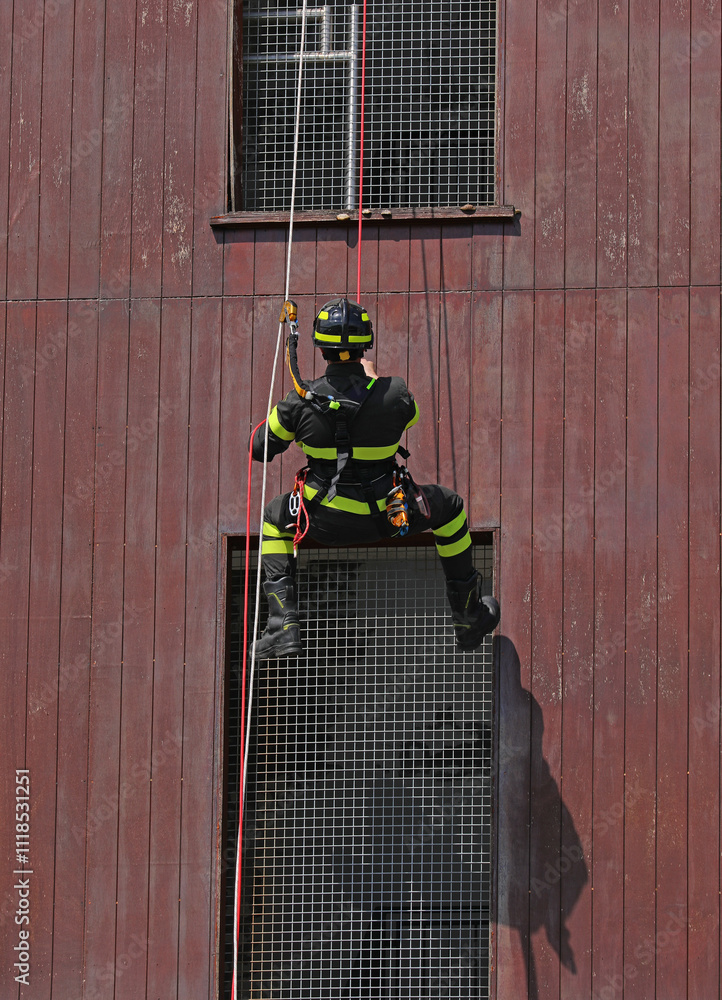 firefighter climbing a building with a safety harness, ropes Stock ...