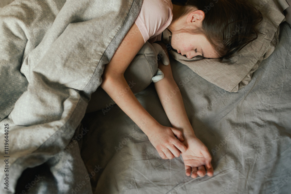 A sick child with skin rashes in bed. Child's skin with many red spot ...