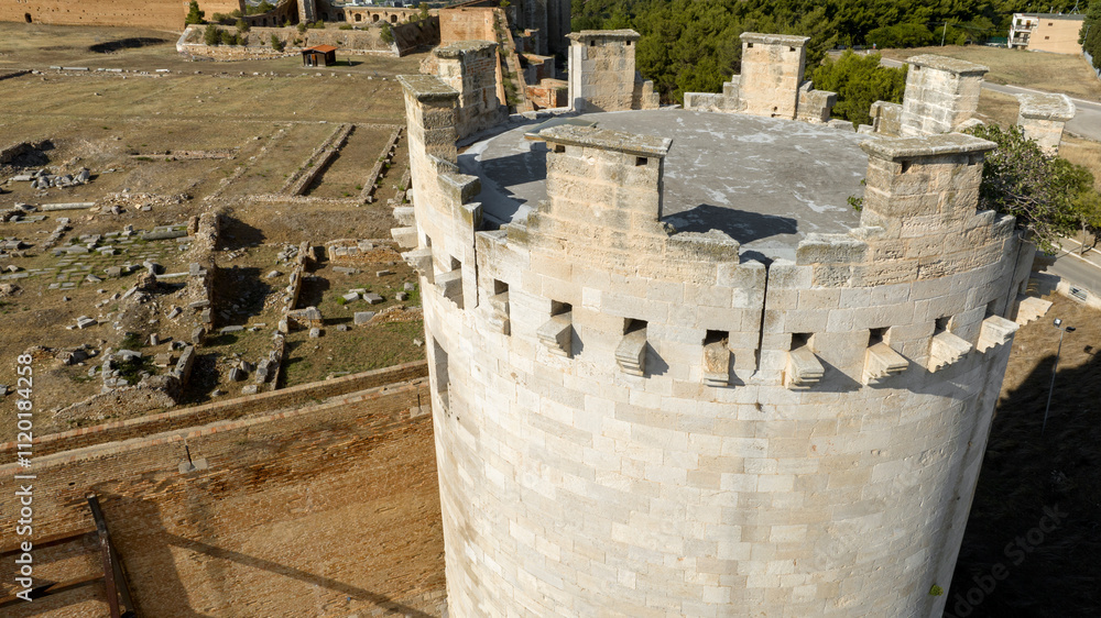 Aerial view of the white tower of a medieval castle. Next to it are the ...