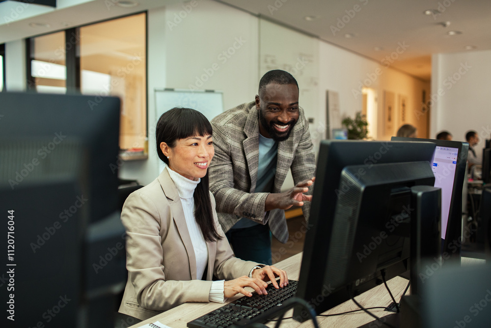 Diverse business people working together on office computer Stock Photo | Adobe Stock
