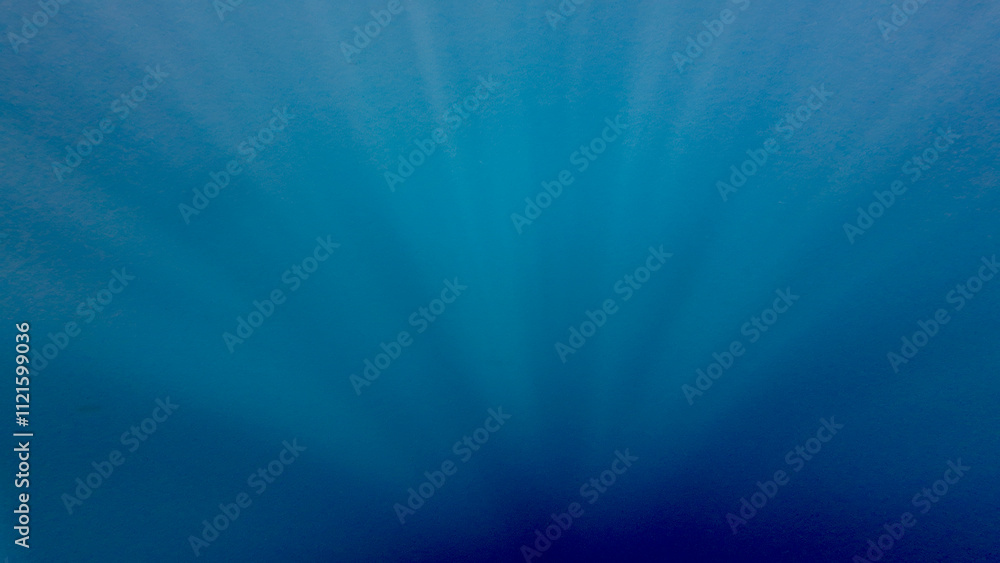 Blue rays background. View from above of the bottomless sea. Sun rays ...