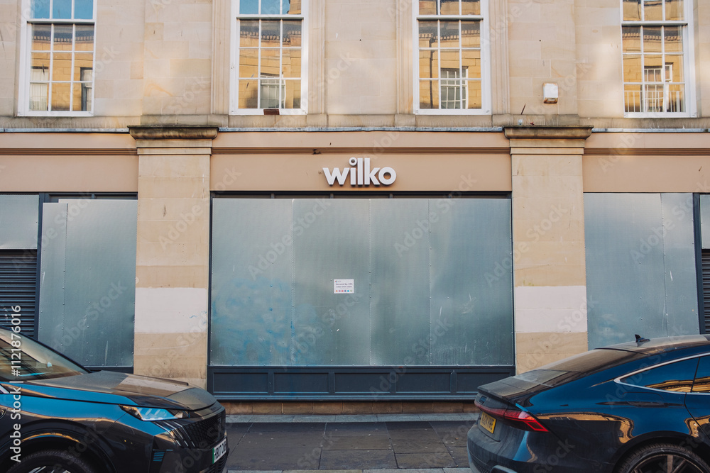 Wilko high street Storefront of a closed retail location with metal ...