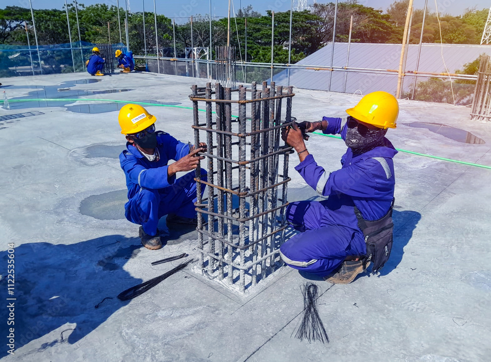 orkers reinforcing a concrete column with steel rebar. Reinforcing ...