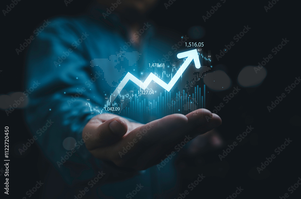 Businessman holding glowing increasing up arrow with stock market graph ...