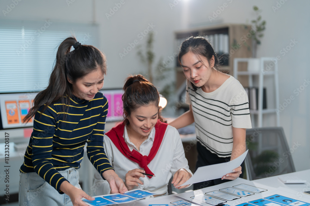 Three Asian Female Ui Ux Designers Working Together Discussing And Designing Mobile App
