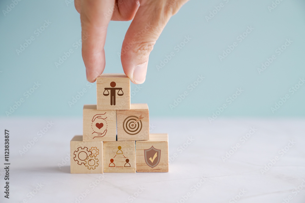 Foto Hand holding wooden block with Ethical icons, business ethics and ...