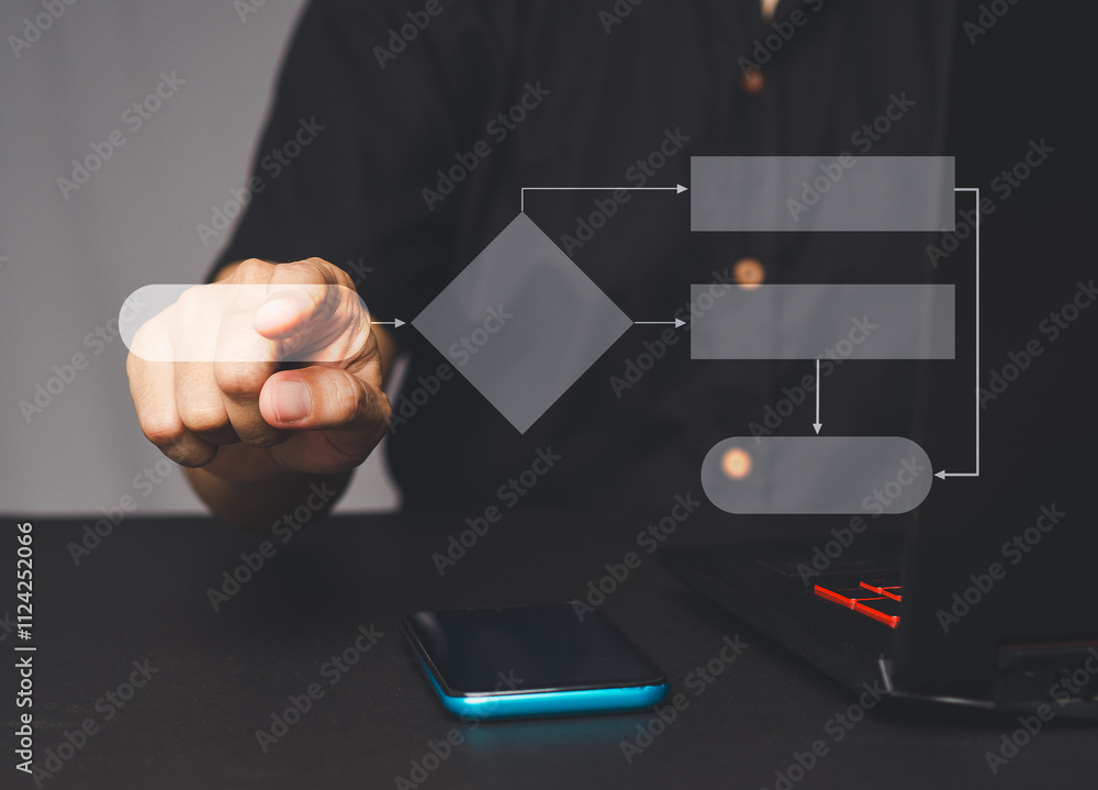 Digital workflow design with a glowing flowchart, hand pointing on ...
