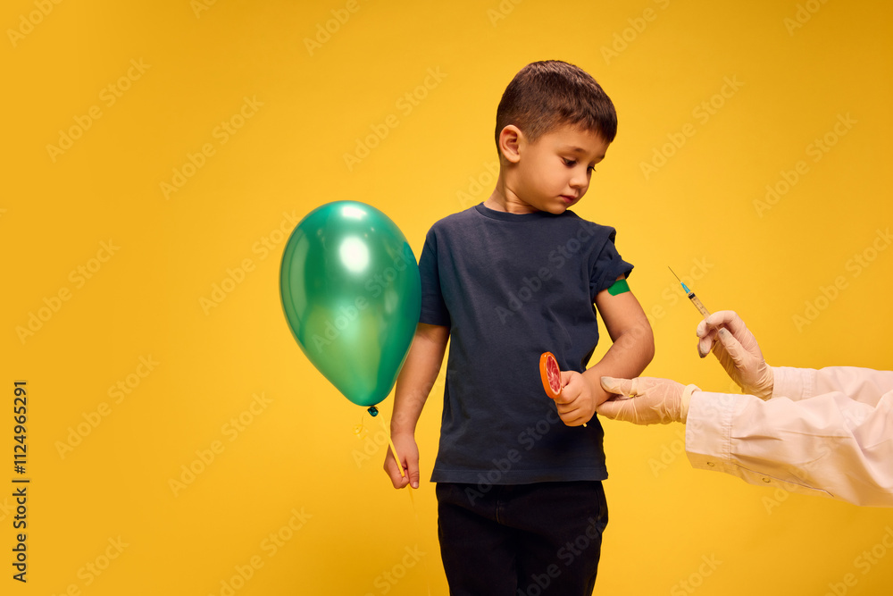 Curious little boy, child with balloon and lollipop attentively looking ...