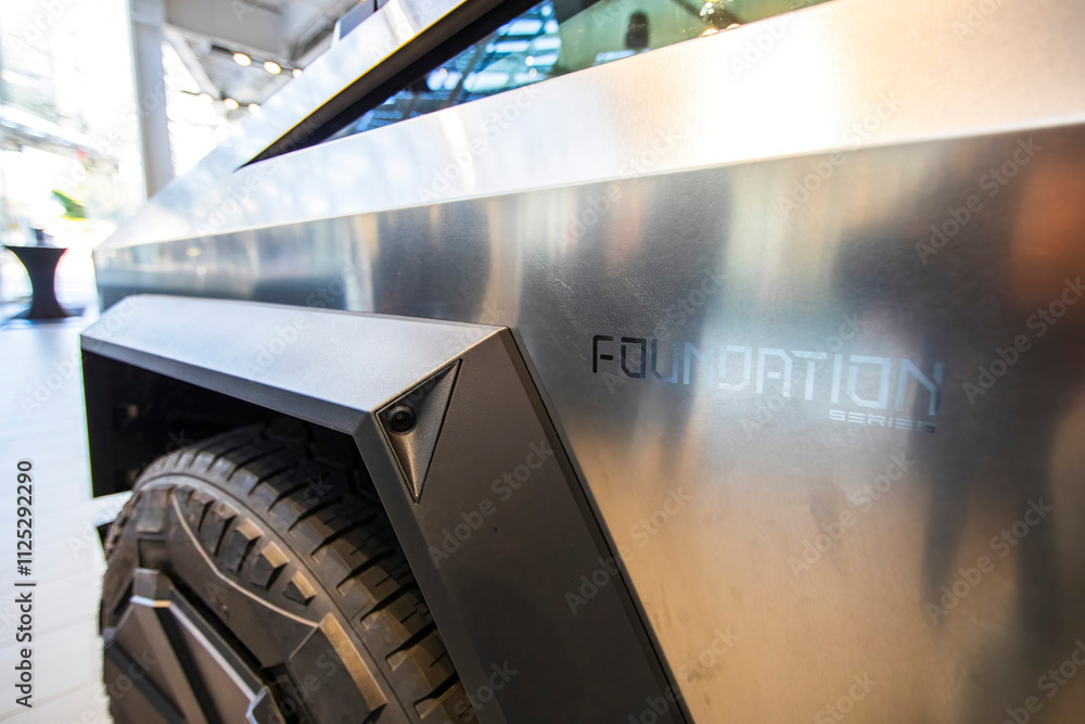 Tesla Cybertruck rear-side view in a showroom, showcasing its angular ...