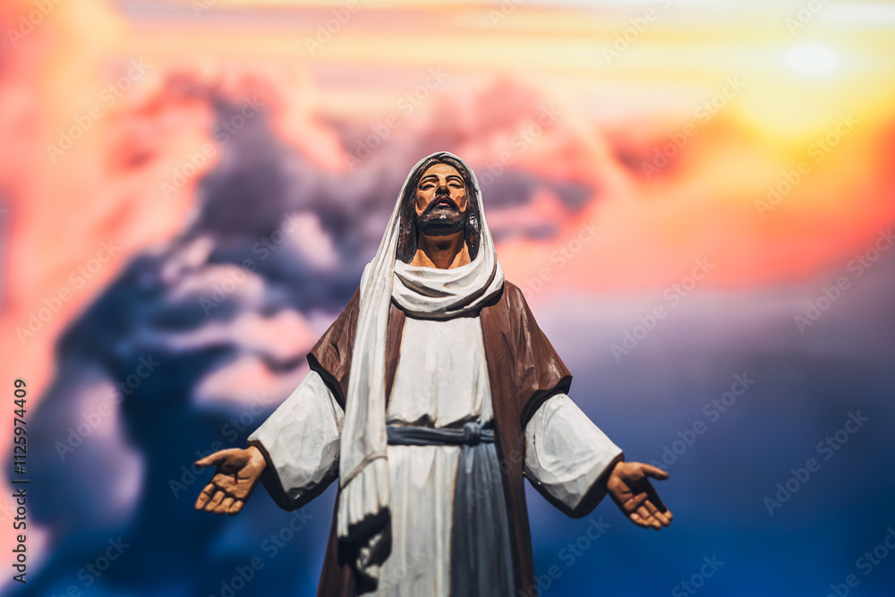 Jesus with arms wide open praying in front of dramatic clouds with the ...