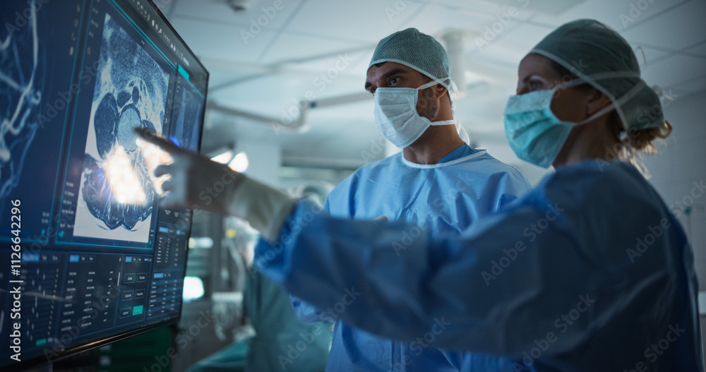 Caucasian Male and Female Surgeons Analyze Patient's Scans on a Digital ...