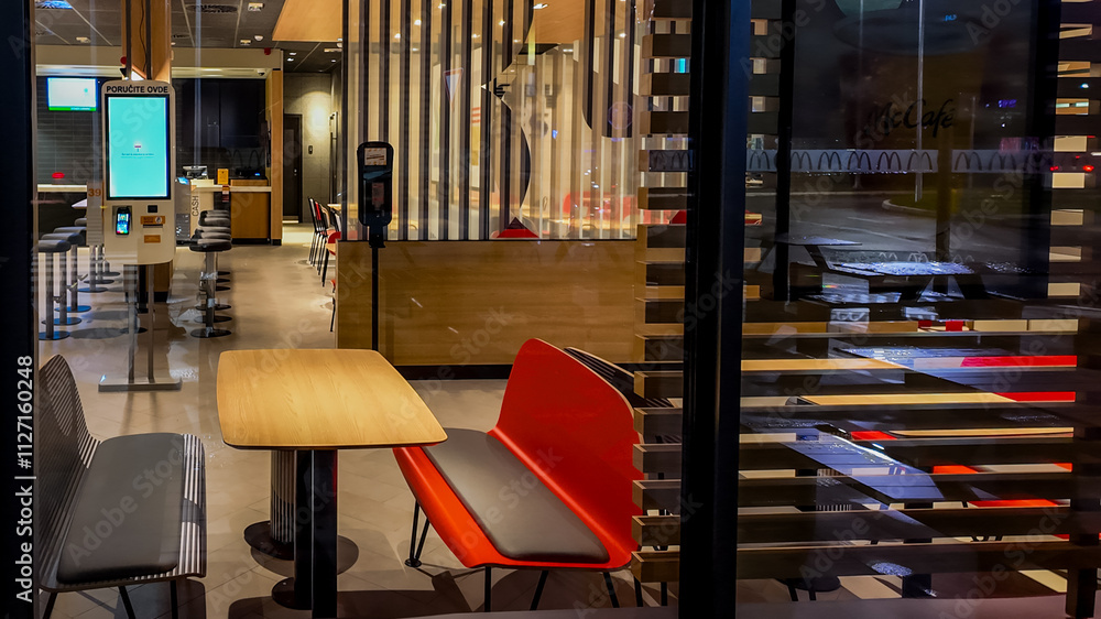 Empty fast food restaurant interior with colorful seating, highlighting ...