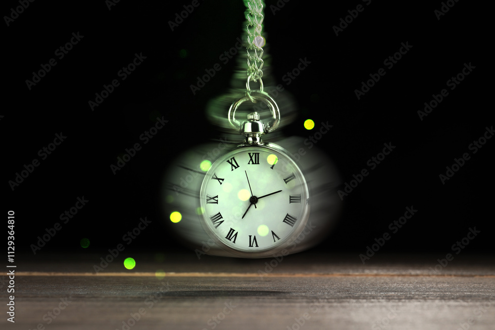Hypnosis session. Vintage pocket watch swinging on black background ...