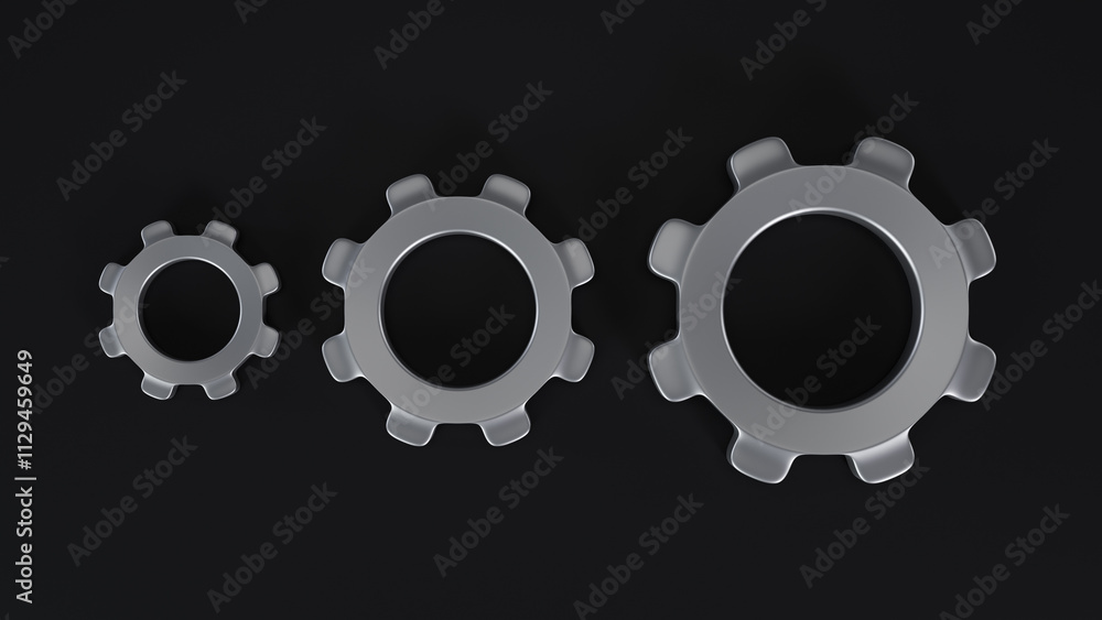 Three metallic gears of different sizes, aligned in an increasing ...