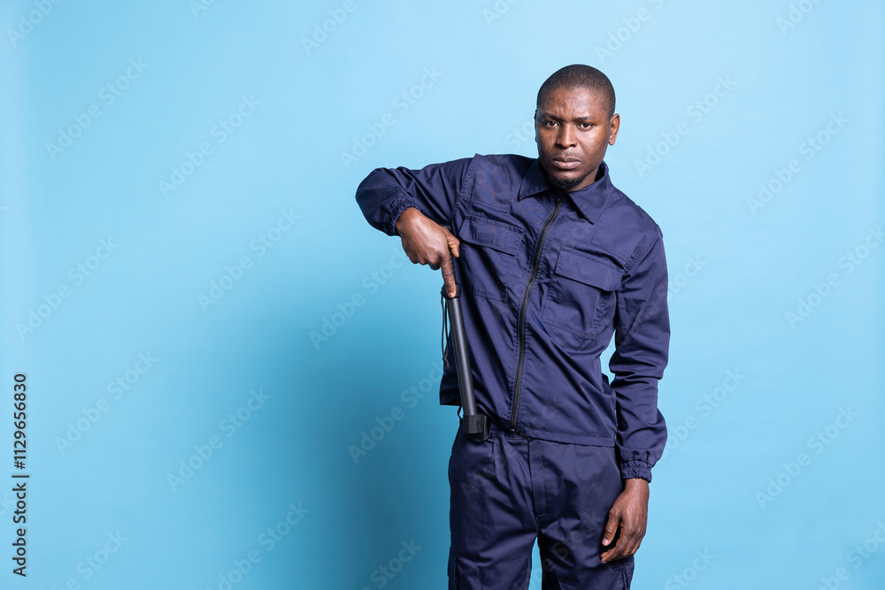 Security guard on duty taking out his weapon against blue background ...