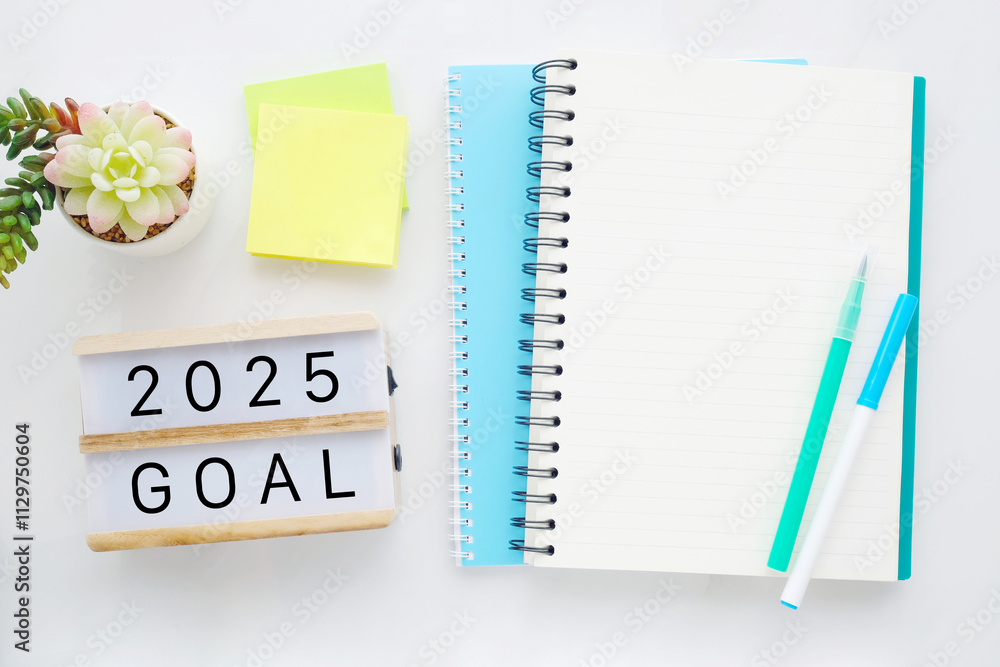 2025 on wood box, blank notebook paper on white marble table background ...