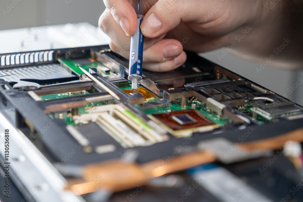 precise application of thermal paste on a laptop processor during ...