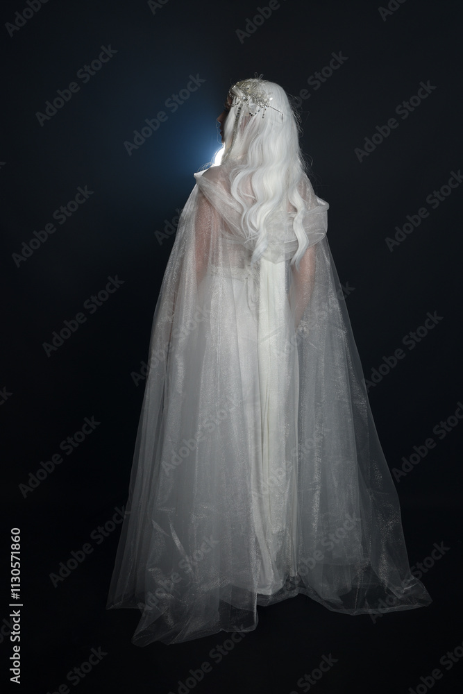 full length portrait of beautiful blonde female model wearing white ...