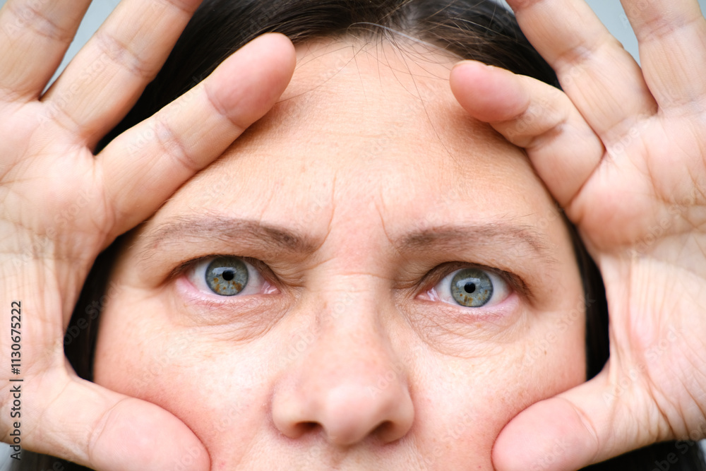 Anxious woman in distress, fingers near eyes, symbolizing fear, worry ...