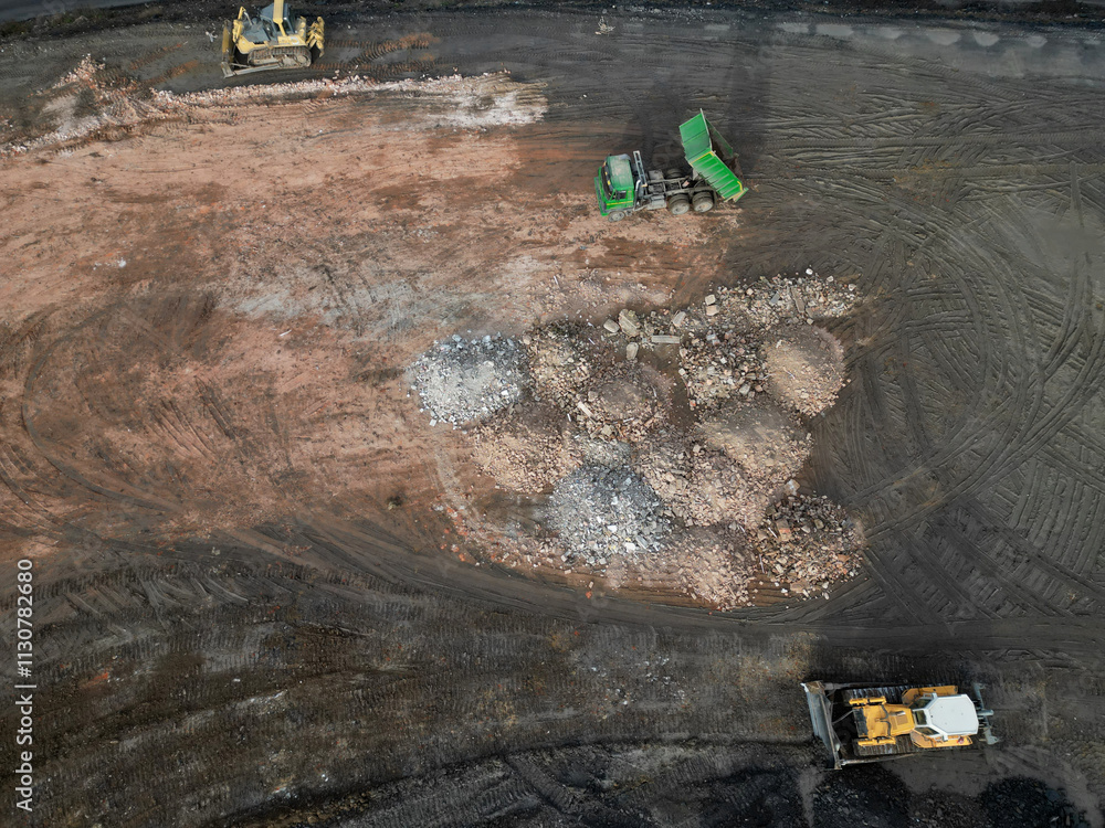 preparation of the construction site, leveling of soil and rubble from ...
