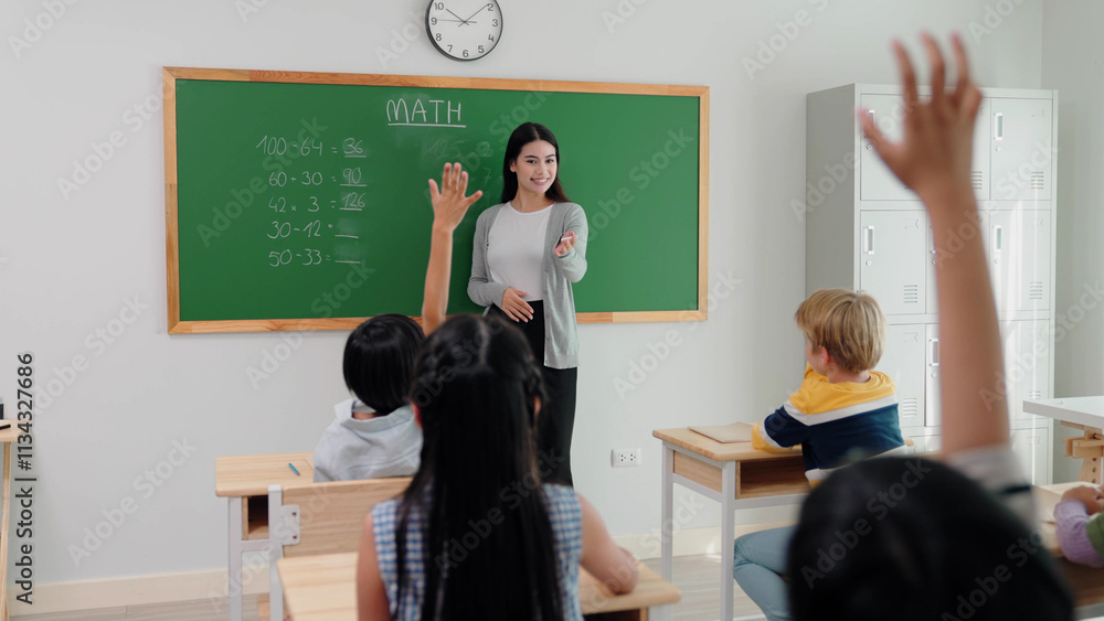Students are competing to raise their hands to answer questions in the ...