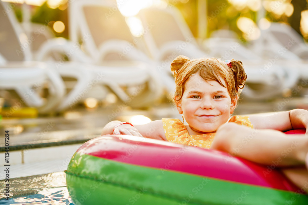 Foto de Stock Happy little girl with inflatable toy ring float in ...
