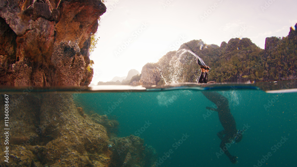 Diver explores a beautiful tropical reef, the split view showcasing the ...