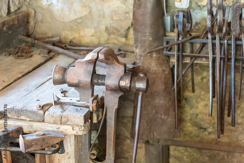 Old iron vice and traditional blacksmith tools in a blacksmith shop ...