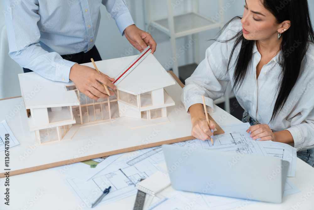 Professional male asian architect using ruler to measure house model ...