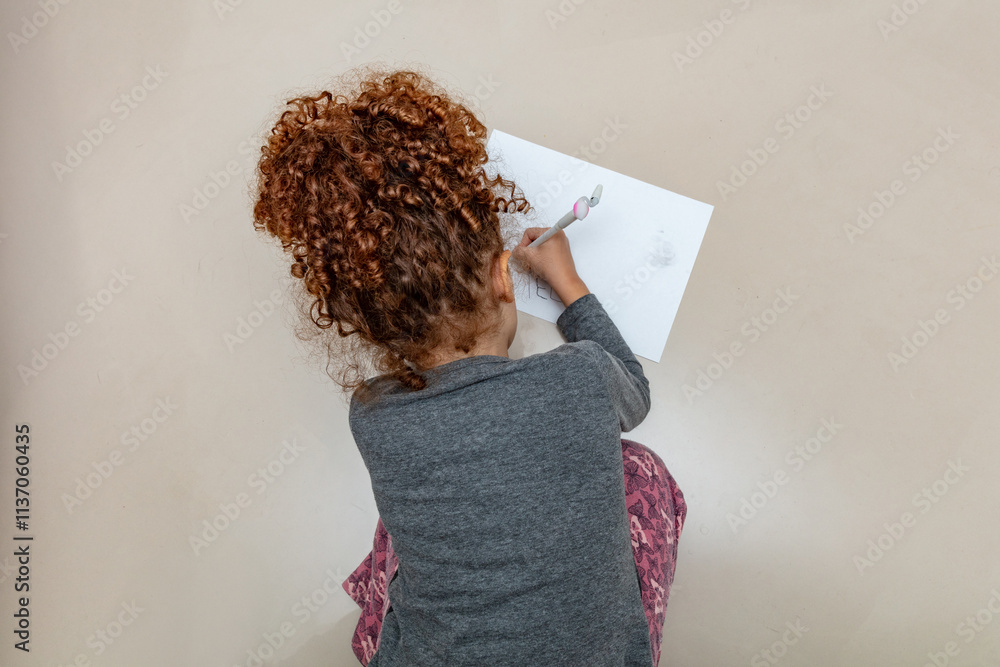Preteen student doing homework with paper at home. Child using pen to ...