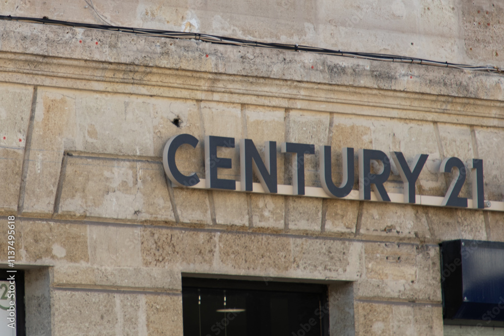Century 21 sign entrance text and brand logo on real estate facade ...