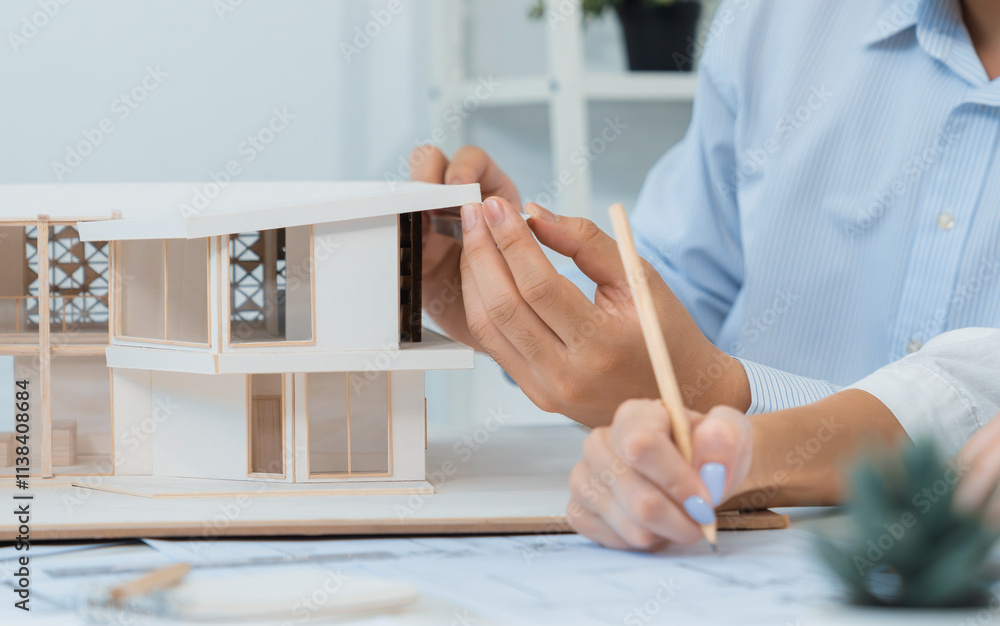 Professional male engineer hand measure house model by using ruler ...