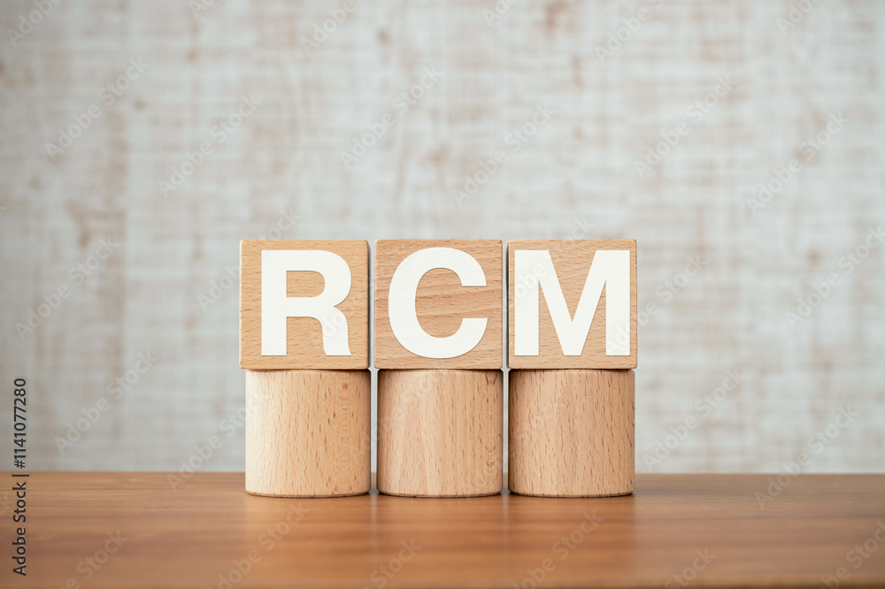 There is wood cube with the word RCM. It is an abbreviation for Risk ...
