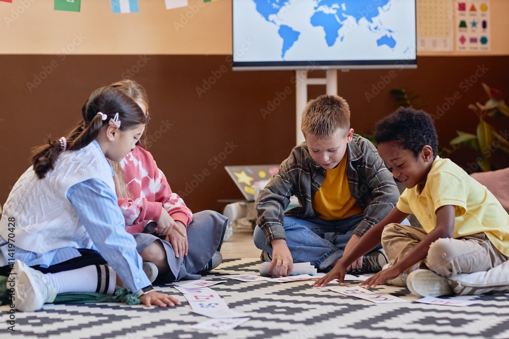 Full length shot of diverse group of kids learning English sitting on ...