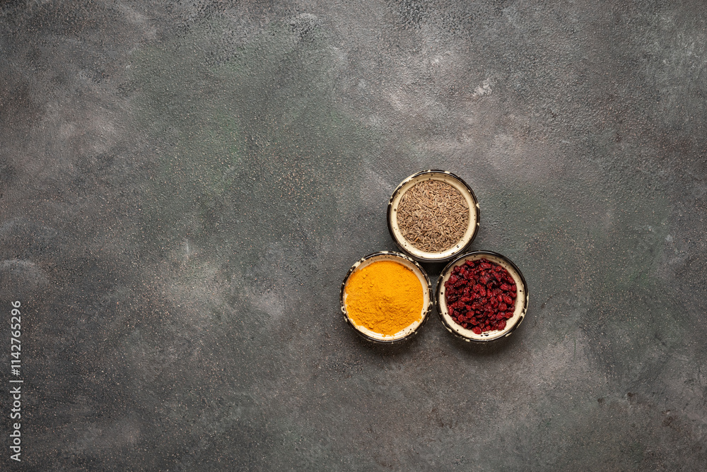 Set of spices for pilaf in a bowl, cumin, turmeric, barberry, top view ...