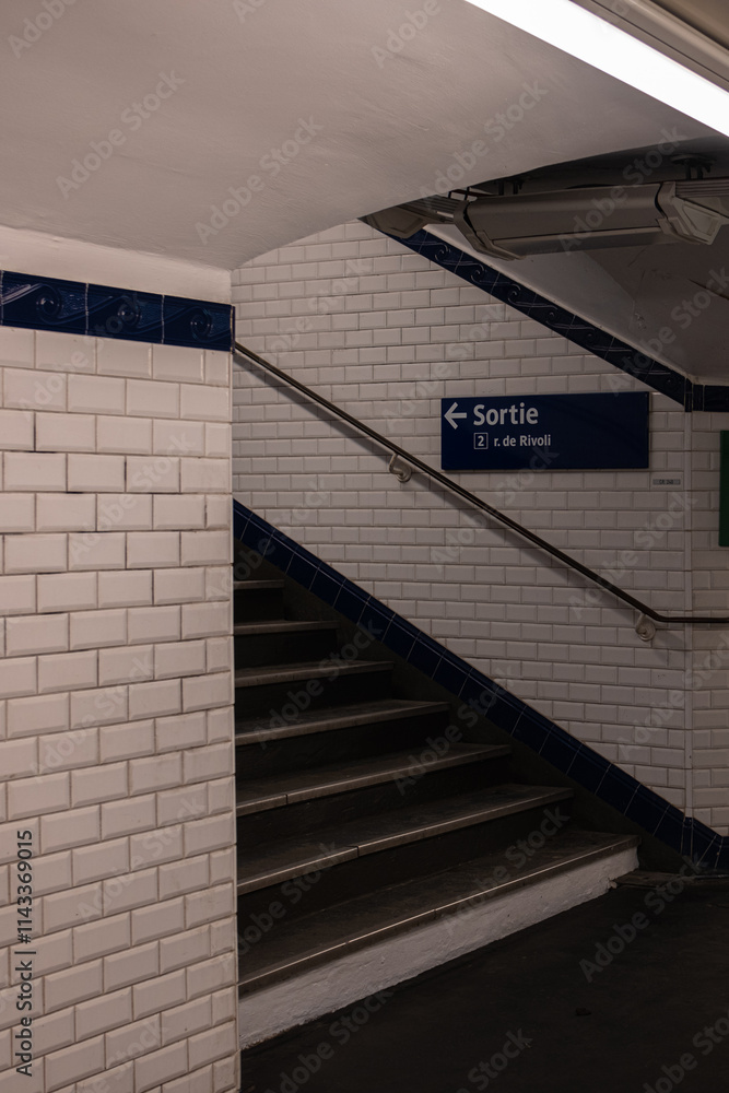 Exit from the Paris metro. Sign: Exit and street name. Steps and a ...