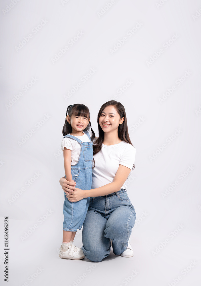 Full body image of Asian mother and daughter posing on white background ...