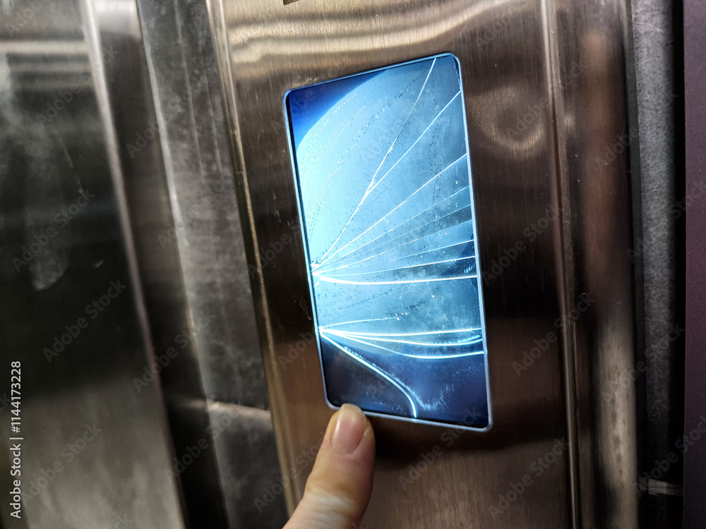 Broken glass on an elevator panel reveals widespread cracks and damage ...