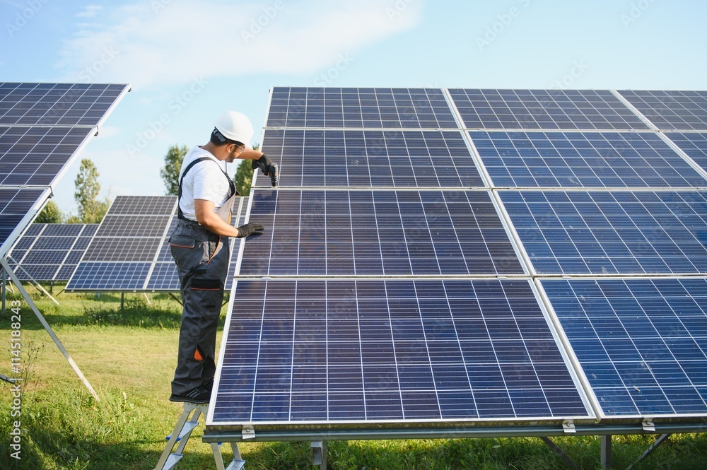 Indian man in uniform on solar farm. Competent energy engineer ...