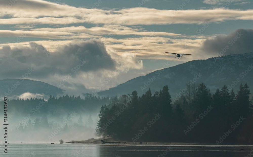 Scenic Light Aircraft Landing Over Misty Forest and Mountain Landscape ...